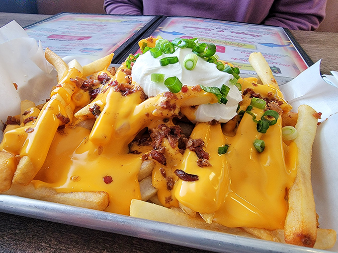 Behold the legendary "Whatever Fries" in all their glory &ndash; a golden mountain of potatoes smothered in cheese, bacon bits, and topped with sour cream.