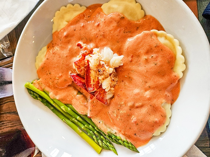 Lobster ravioli that makes pasta jealous. Those tender pillows swimming in blush sauce with asparagus are basically edible postcards from heaven.