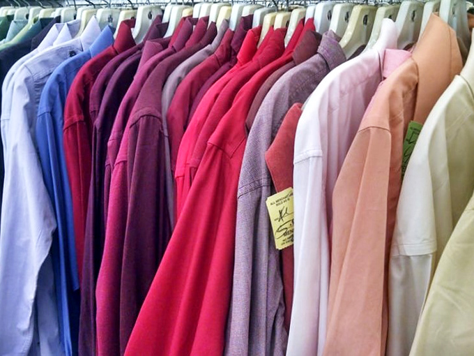 A rainbow of button-downs and blouses stands at attention, each garment whispering, "Take me home, I promise I'll make you look fabulous."