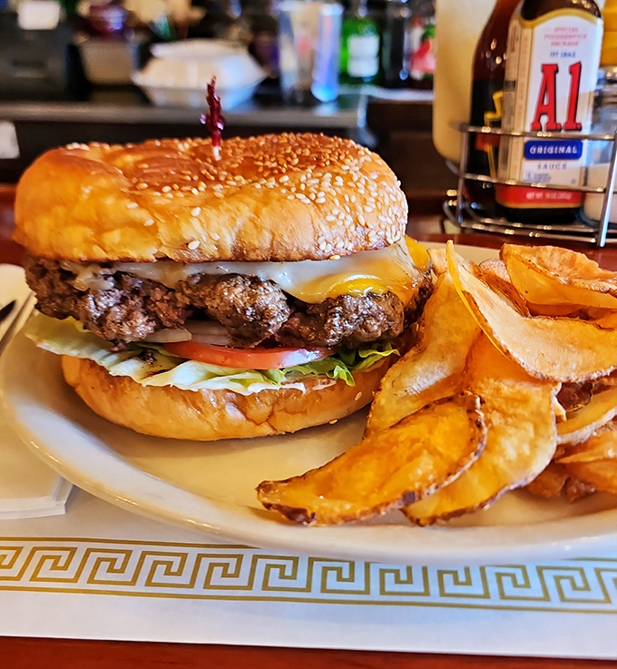 Behold the star attraction: a burger so substantial it has its own gravitational pull, paired with golden potato wedges that demand equal attention.