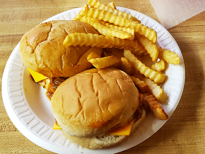Behold the star of the show: a cheeseburger so gloriously unpretentious it makes fancy $20 bistro burgers weep with inadequacy. Those crinkle-cut fries aren't just sidekicks—they're co-stars.