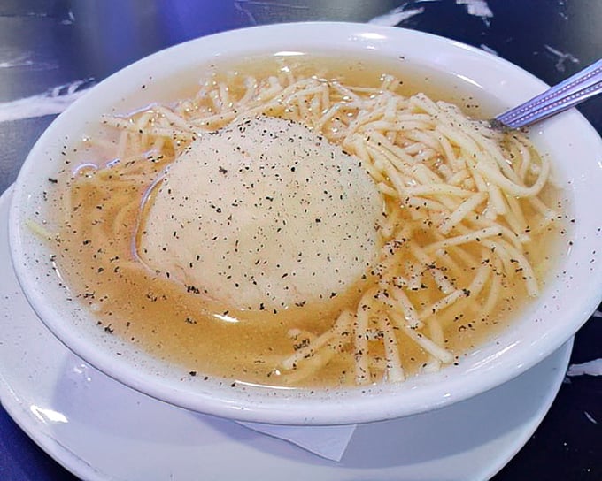 The star of the show: a matzo ball floating like a full moon in a galaxy of golden broth and noodles. Jewish penicillin at its finest.