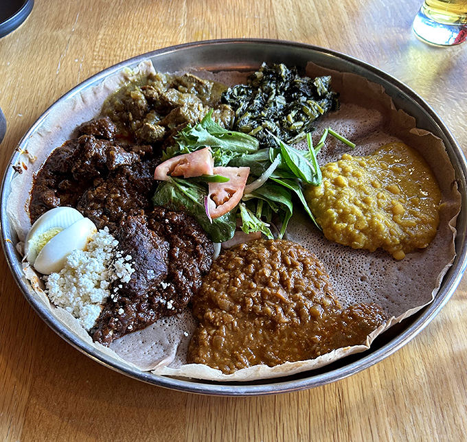 This isn't just dinner&mdash;it's edible artwork. A rainbow of Ethiopian stews nestled on injera, with that hard-boiled egg in doro wat stealing the spotlight.