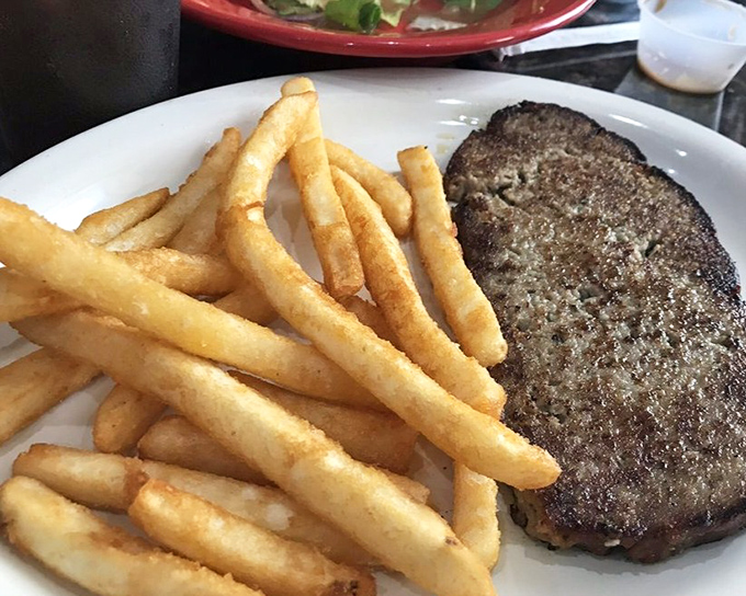A perfectly seared burger patty with golden fries&mdash;the kind of plate that makes you forget about fancy food trends in an instant.