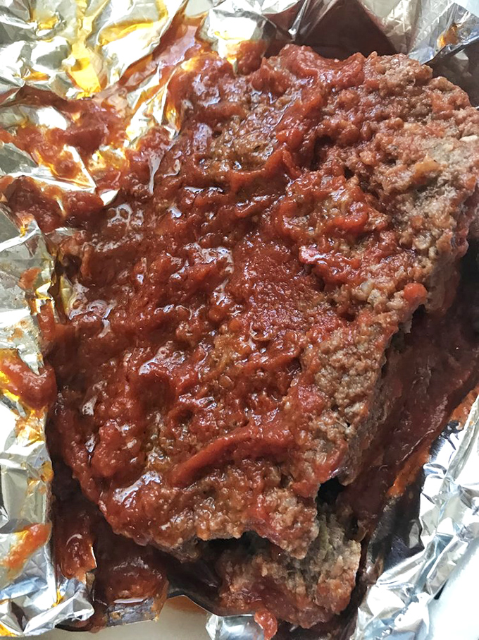 Behold the legendary meatloaf in all its saucy glory. Not the prettiest dish you'll ever see, but possibly the most memorable love affair your fork will ever have.