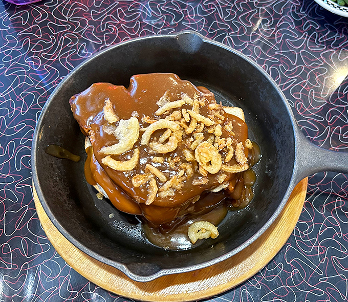 Behold the legendary Meatloaf Stack &ndash; a skyscraper of comfort topped with crispy onions and swimming in savory gravy.