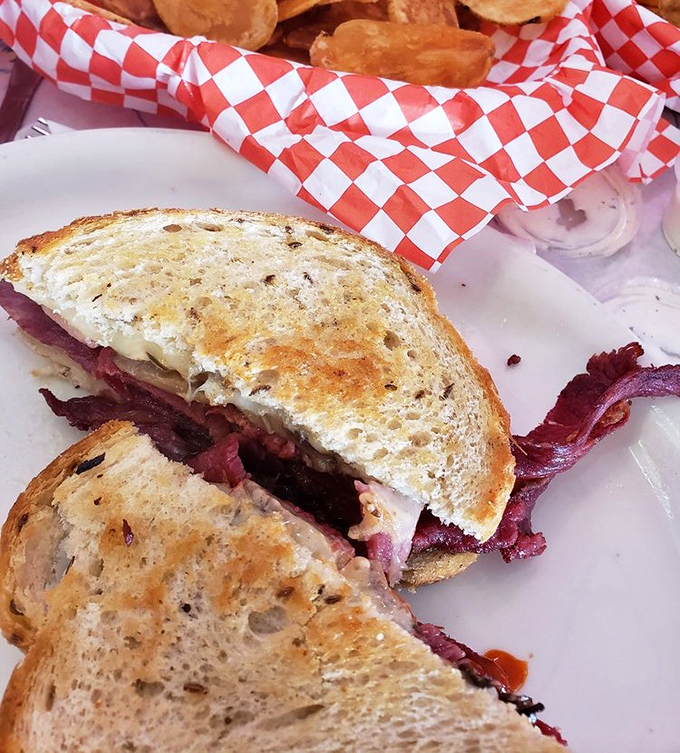 This Reuben sandwich isn't just lunch&mdash;it's architecture. Look at those layers of corned beef peeking out like they're trying to escape!