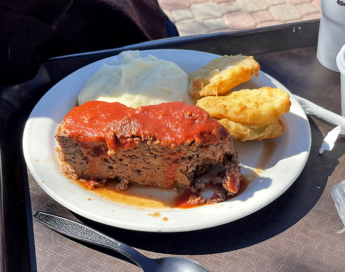 Behold the star attraction: Matthews' legendary meatloaf with that perfect tomato glaze, flanked by creamy mashed potatoes and golden cornbread.