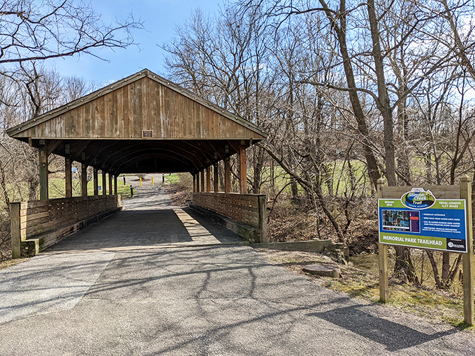 A covered bridge welcomes trail enthusiasts, standing like a wooden time portal between today's hustle and yesterday's pace.