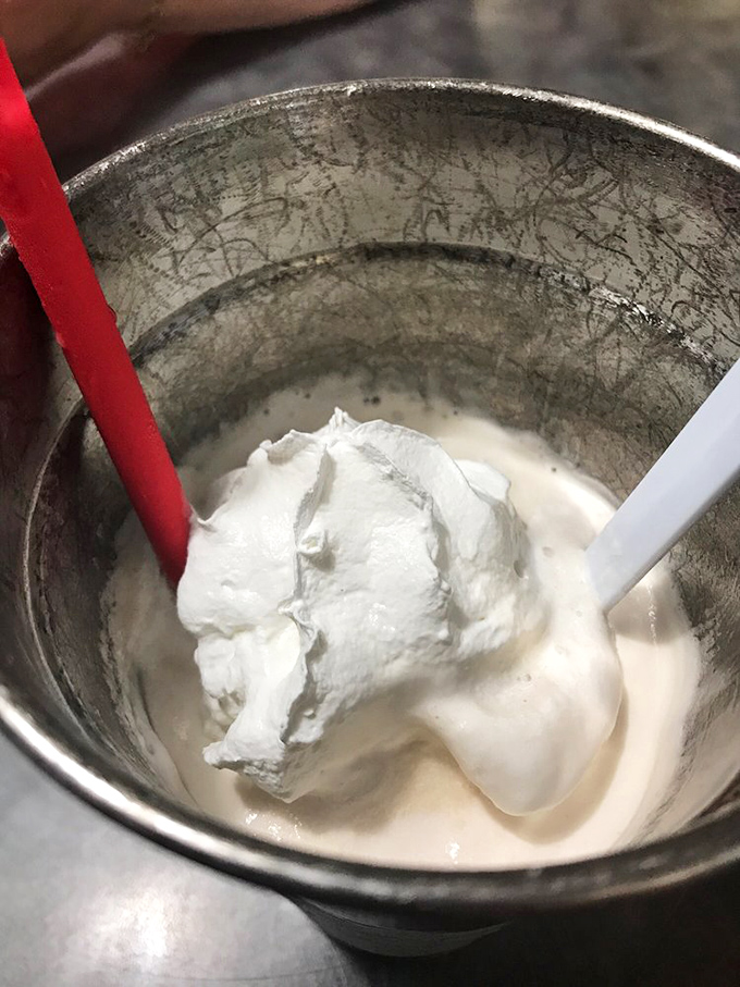 The milkshake mixing ritual&mdash;where dairy transforms into dreams. This metal mixing cup holds the secret formula that makes adults remember why being a kid was so sweet.