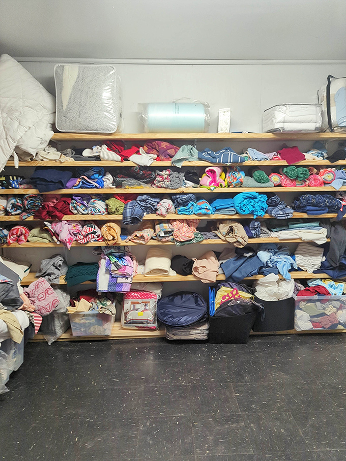 Shelves packed with folded treasures prove that organization and thrift store chaos can coexist in beautiful harmony.