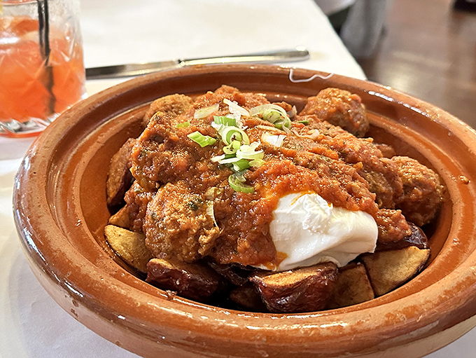 The Moroccan tagine arrives like a magic carpet ride in a clay pot, complete with tender chicken and exotic spices.