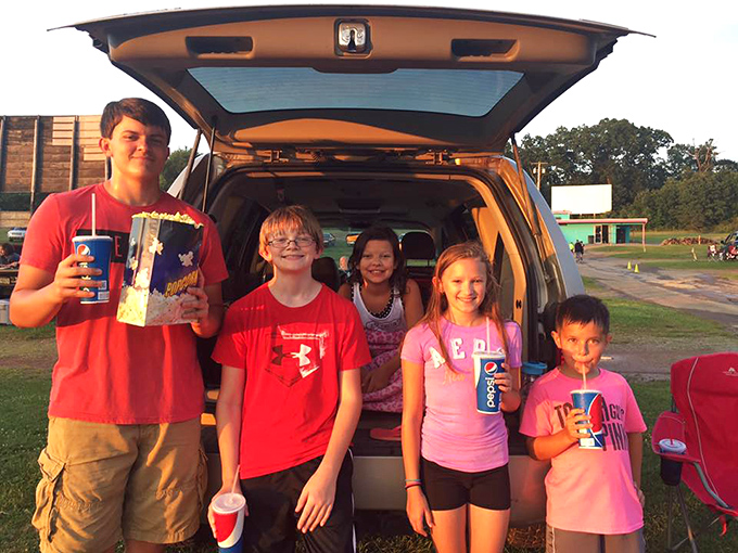 Family movie night reimagined! These young cinephiles have mastered the art of tailgate viewing with snacks at the ready.