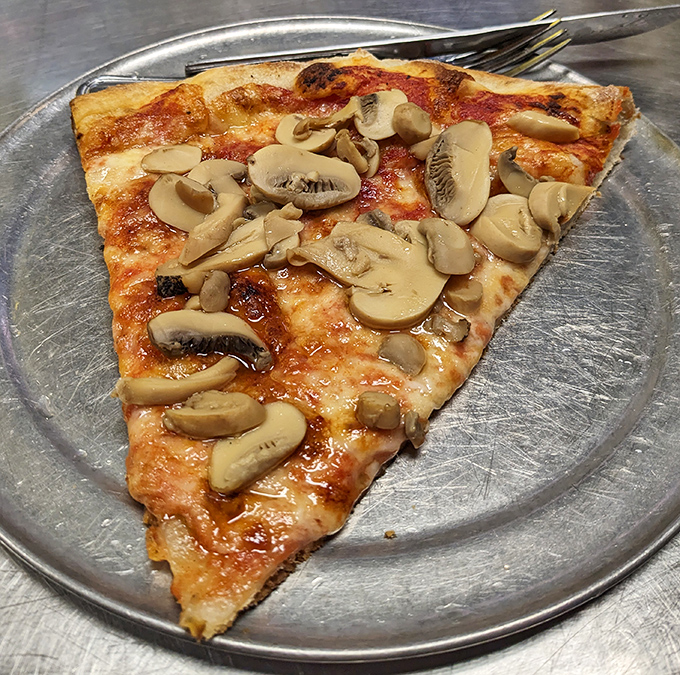 Mushroom pizza that makes fungi skeptics reconsider their life choices. Each slice offers that perfect sauce-to-cheese ratio that pizza dreams are made of.