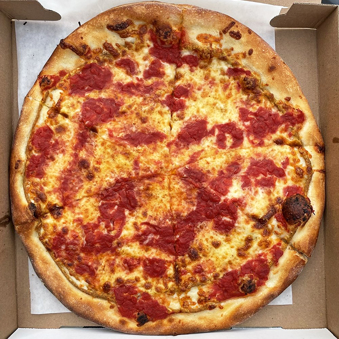 Behold the tomato pie in its natural habitat! The sauce-on-top approach isn't just tradition&mdash;it's revelation. That perfectly charred crust is the stuff of pizza dreams.