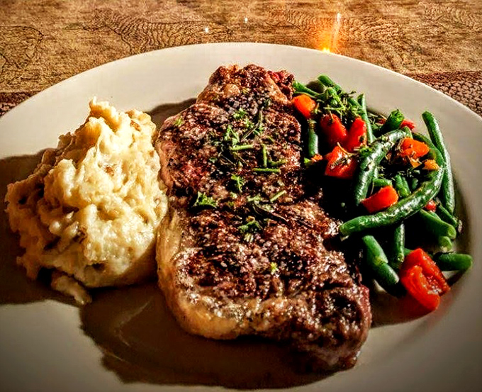 Not just a steak—a masterpiece on a plate. The NY Strip arrives with perfect grill marks, fluffy mashed potatoes, and green beans that actually taste like vegetables should.