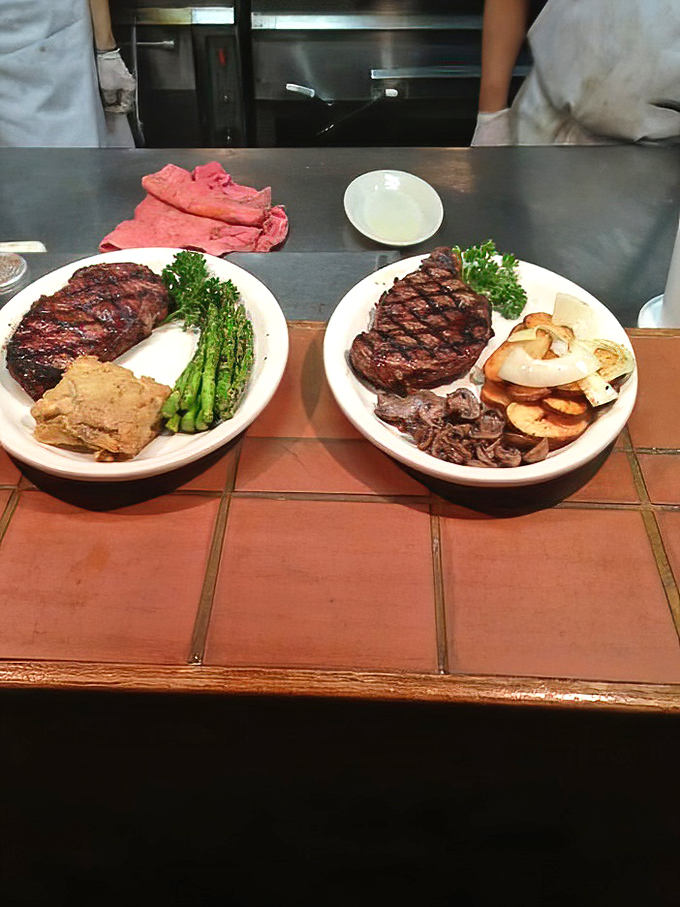 Two perfectly charred steaks flanked by vibrant asparagus and golden potatoes. This isn't just dinner&mdash;it's edible artwork that happens to taste even better than it looks.