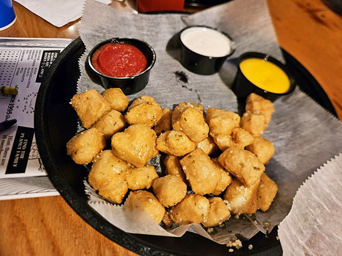 Golden-brown beer nuggets arrive like treasure chest bounty, accompanied by dipping sauces that turn these pillowy bites of pizza dough into an irresistible addiction.