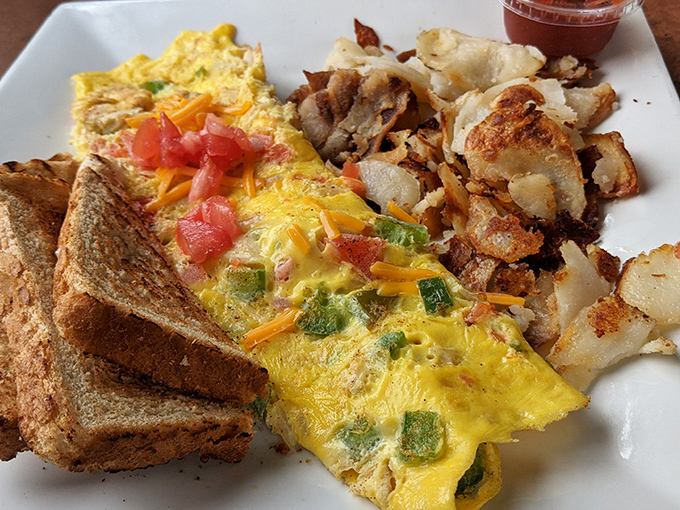This isn't just an omelet&mdash;it's a masterclass in egg architecture, with perfectly crisp home fries standing guard alongside buttery toast soldiers.