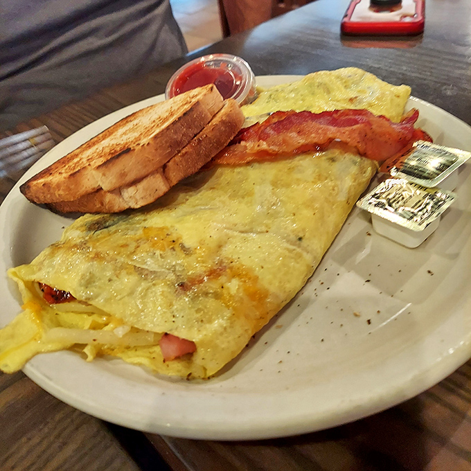Behold the omelet that launched a thousand road trips – golden, glorious, and bigger than your breakfast ambitions.