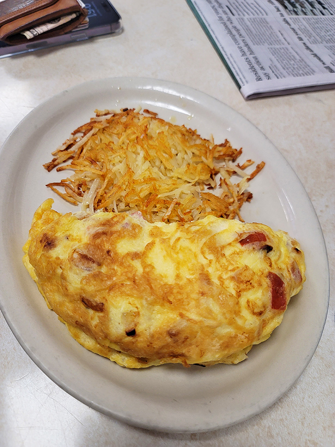 Behold the omelet&mdash;a golden pillow of egg perfection nestled against crispy hash browns. Simplicity that somehow manages to be revolutionary.