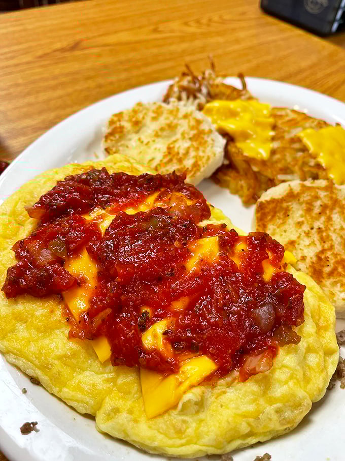 Behold the omelet in its natural habitat&mdash;perfectly folded, generously stuffed, and topped with what appears to be a salsa-cheese combination that dreams are made of.