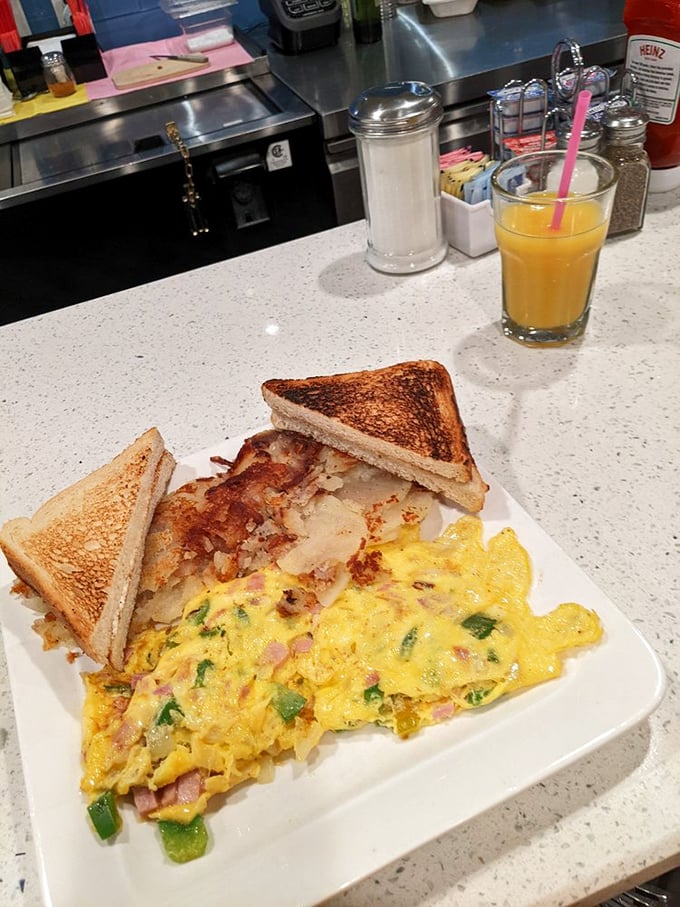 This isn't just an omelet; it's a morning masterpiece with perfectly diced peppers and ham nestled in fluffy eggs.