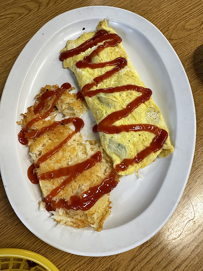 The Western omelet arrives like a golden sunrise on a plate. Perfectly folded eggs housing a treasure of ham, peppers, and cheese worth setting your alarm for.