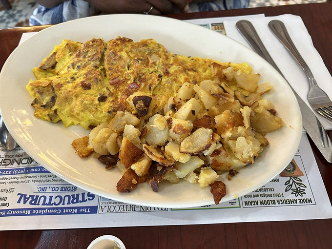 This is what breakfast dreams are made of &ndash; a perfectly executed omelet with crispy home fries. The kind of plate that makes you question all other breakfast choices.