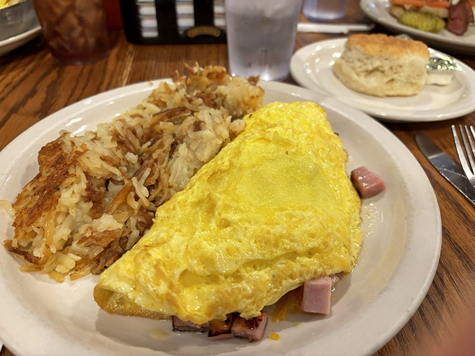 This ham and cheese omelet isn't just breakfast, it's edible sunshine alongside hash browns that have achieved that perfect crisp-to-tender ratio.