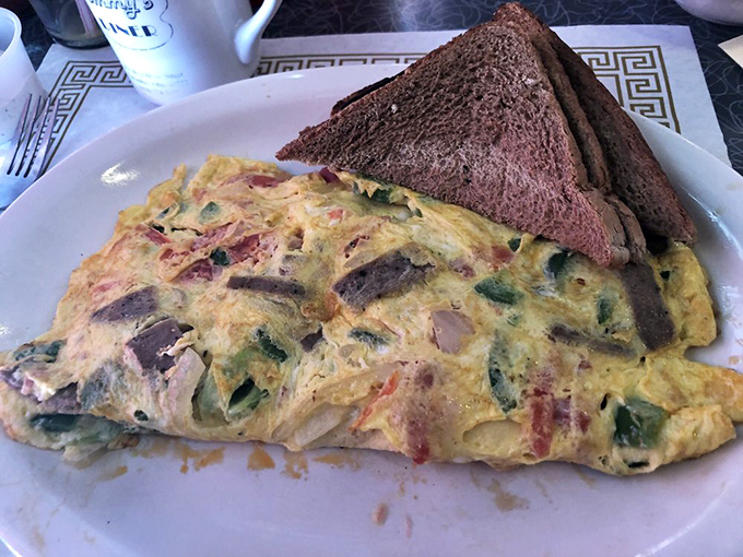 This isn't just an omelet&mdash;it's a masterpiece of egg architecture, stuffed with goodies and served with toast that's actually toasted properly.
