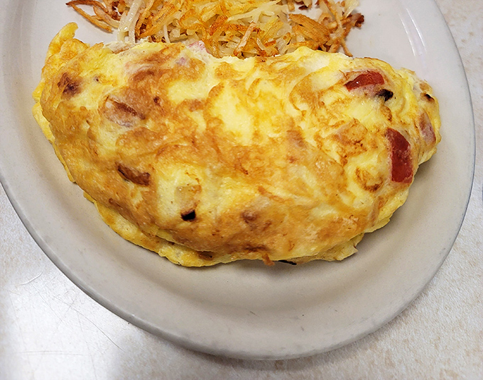 Not all heroes wear capes—some come folded over ham and cheese, perfectly executed and paired with hash browns that deserve their own fan club.