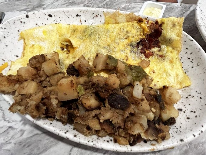 This omelet doesn't just sit on the plate&mdash;it sprawls luxuriously, like it's on vacation too, surrounded by perfectly crisped potatoes.