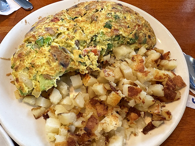 This isn't just an omelet&mdash;it's a golden-hued masterpiece with vegetables distributed with the precision of a Renaissance painting. Michelangelo would approve.