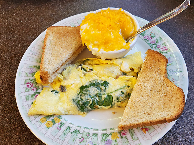 This isn't just any omelet &ndash; it's a fluffy canvas of egg perfection, where spinach and cheese unite in breakfast harmony.