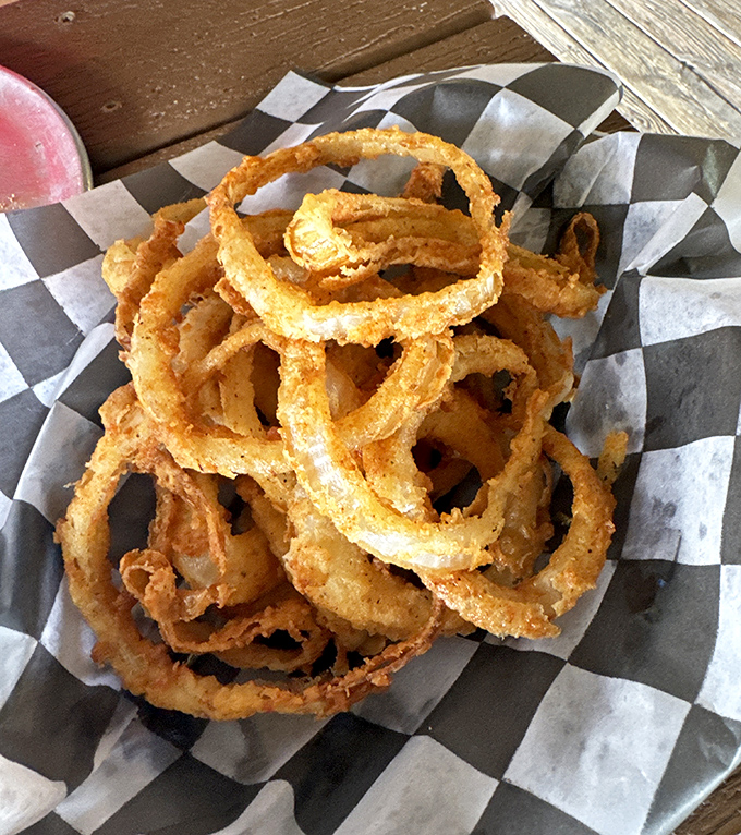 The golden halos of Sevierville. These onion rings aren't just fried, they're transformed into crispy, ethereal circles of joy that make vegetables worth eating.
