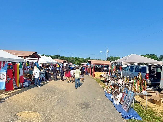 Sunday shoppers navigate the market's arteries, where white tents form a makeshift village of possibilities under Alabama's generous sky.