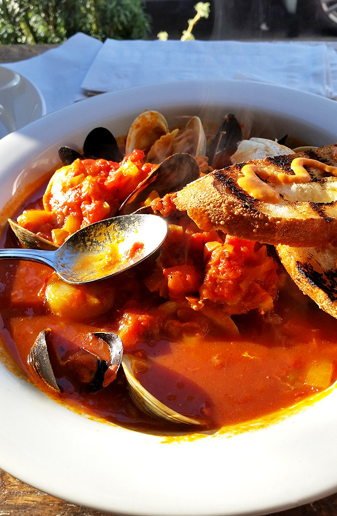 This isn't just seafood stew; it's a maritime celebration in a bowl, complete with clams that practically high-five your taste buds.