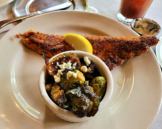 This walleye isn't just dinner—it's Minnesota's state fish given the royal treatment it deserves. That golden crust is what food dreams are made of.