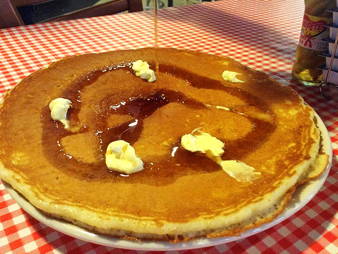 Behold the pancake that ate Manhattan! Golden-brown, bigger than your plate, and waiting for its maple syrup baptism.