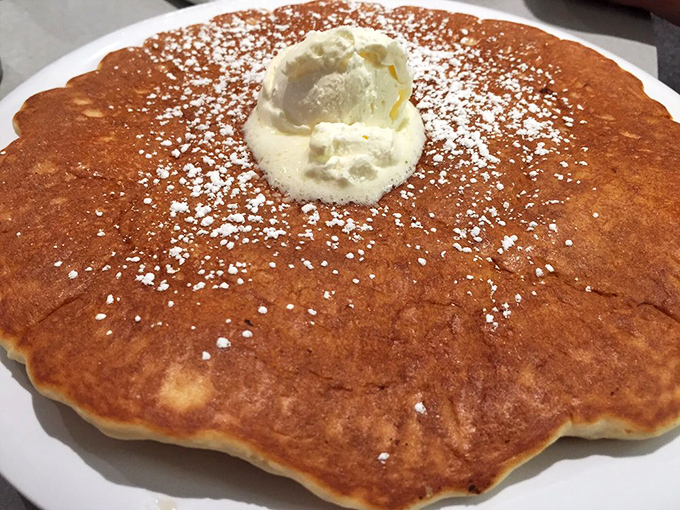 Behold a pancake so magnificently golden and fluffy, it could double as a throw pillow in a particularly delicious bedroom.
