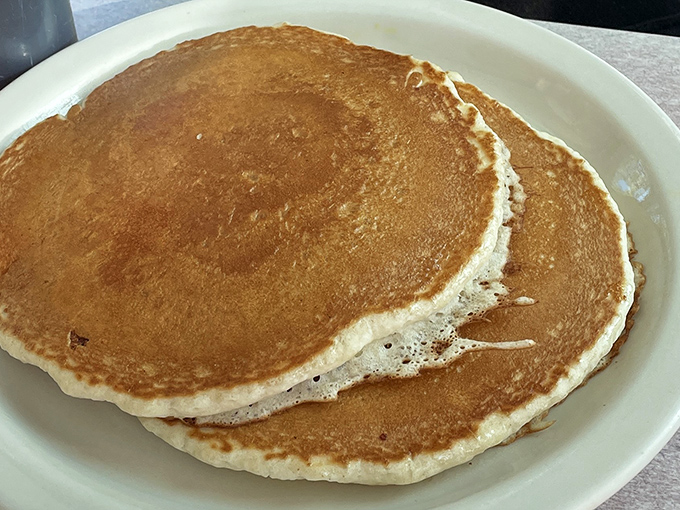 These golden pancakes aren't just breakfast—they're edible sunshine on a plate, with that perfect balance of fluffy interior and slightly crisp edges.
