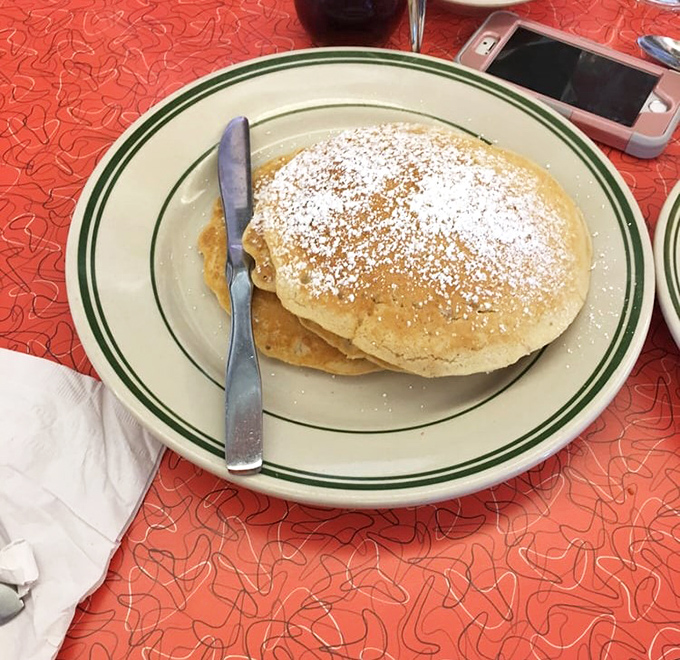 These pancakes aren't just breakfast, they're edible clouds dusted with powdered sugar snow. One bite and you'll understand why mornings were invented.