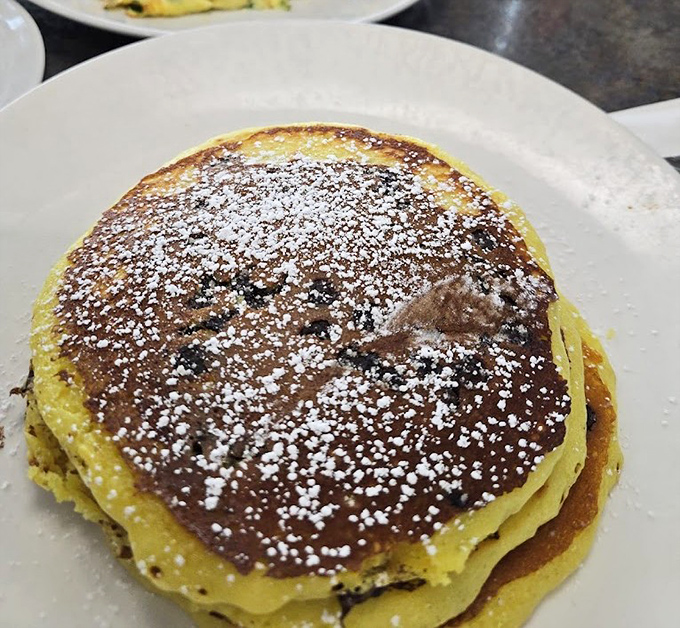 These golden pancakes dusted with powdered sugar aren't just breakfast&mdash;they're edible pillows of joy that make mornings worth facing.