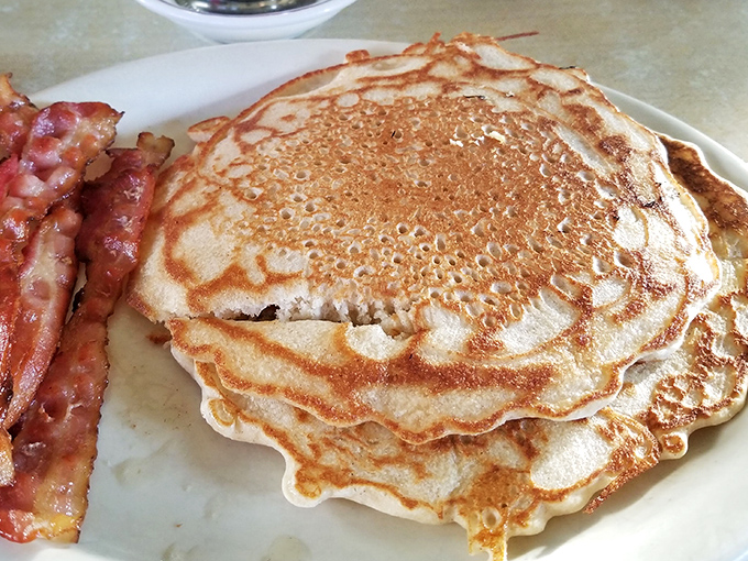 These aren't just pancakes; they're golden-brown masterpieces with perfectly crisp edges that make you wonder if your grandmother secretly moonlights in the kitchen.