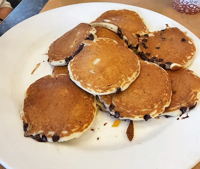 Chocolate chip pancakes that don't just satisfy hunger but solve existential crises. Golden-brown perfection with melty chocolate pockets of pure joy.