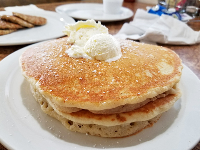Fluffy pancakes crowned with butter that could double as frisbees, golden brown perfection that makes every Tuesday feel like a special occasion.