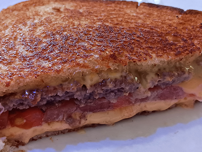 Behold the star attraction: perfectly grilled rye bread embracing a juicy patty and melted cheese&mdash;comfort on a plate.