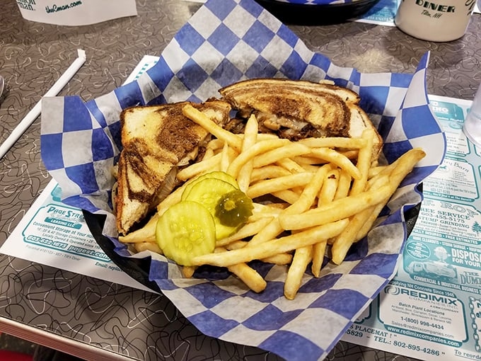 The holy trinity of diner perfection: golden-grilled rye, melted cheese cascading over seasoned beef, and those fries&mdash;crispy on the outside, cloud-soft within.