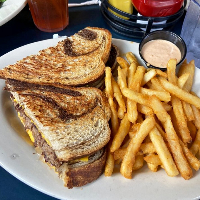 Behold the star of the show: Fitz's legendary Patty Melt, perfectly grilled with those Instagram-worthy cross-hatch marks that whisper, "Yes, this will change your life."